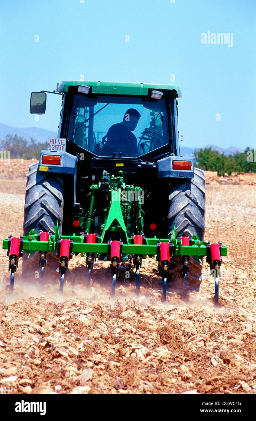 Tractor dragging a plough Stock Photo - Alamy