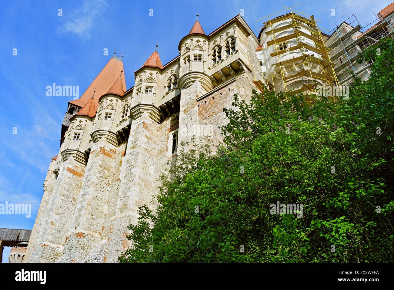 Bottom-up view of the medieval gothic Corvin Castle located in the city ...
