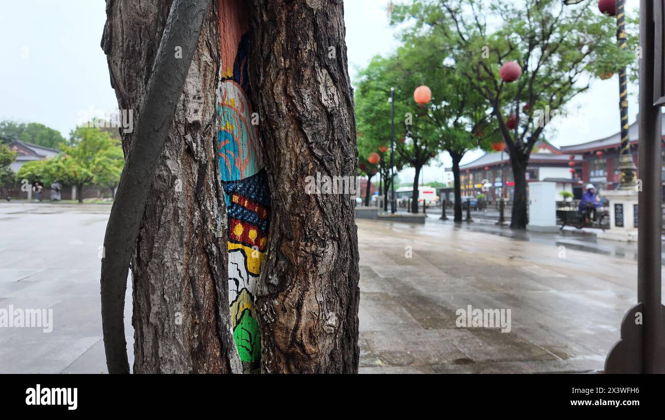 XI'AN, CHINA - APRIL 29, 2024 - A scarred tree draws a cartoon drawing ...