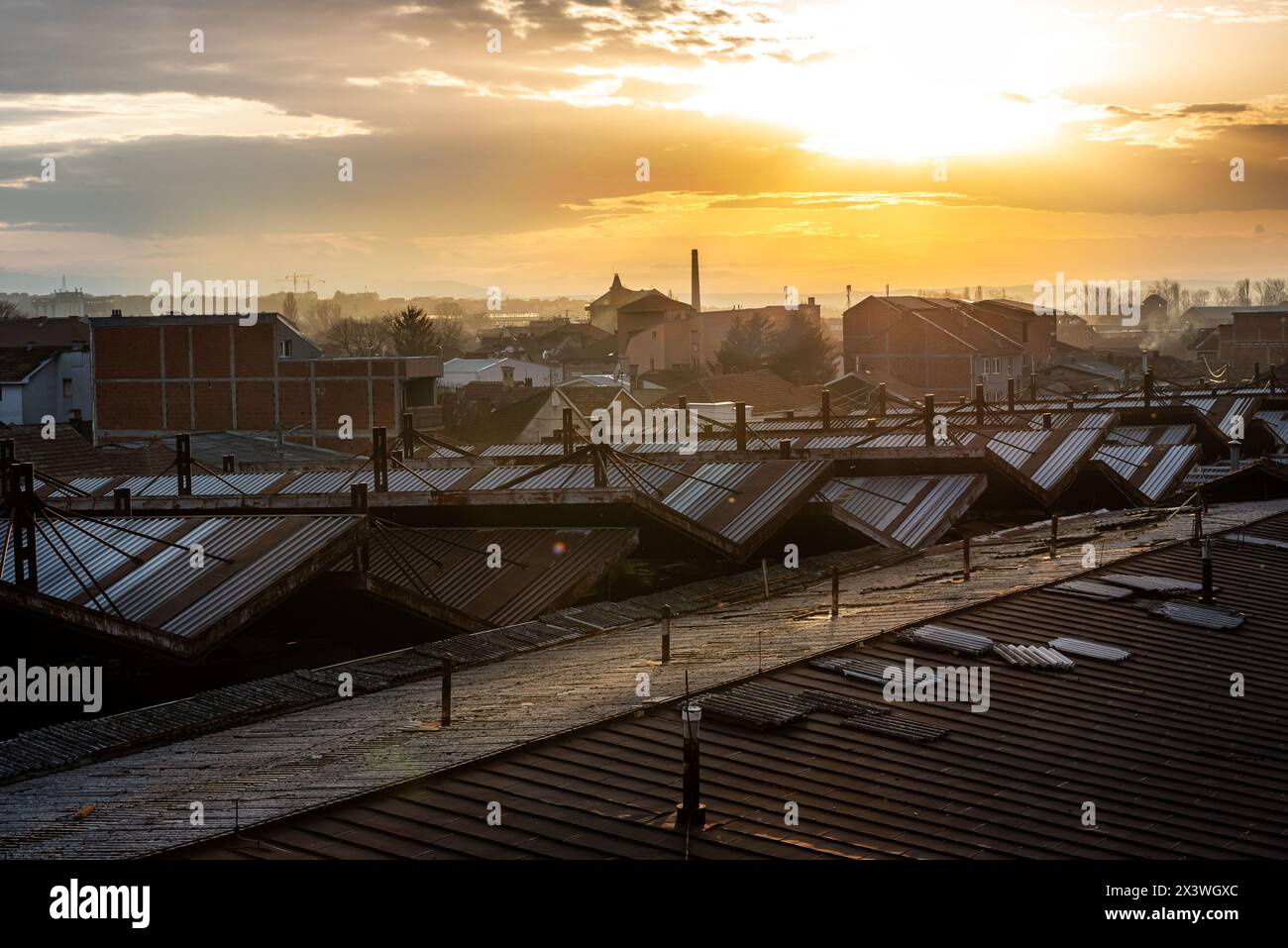 Industrial suburb rooftops and cityscape at a beautiful sunset Stock ...