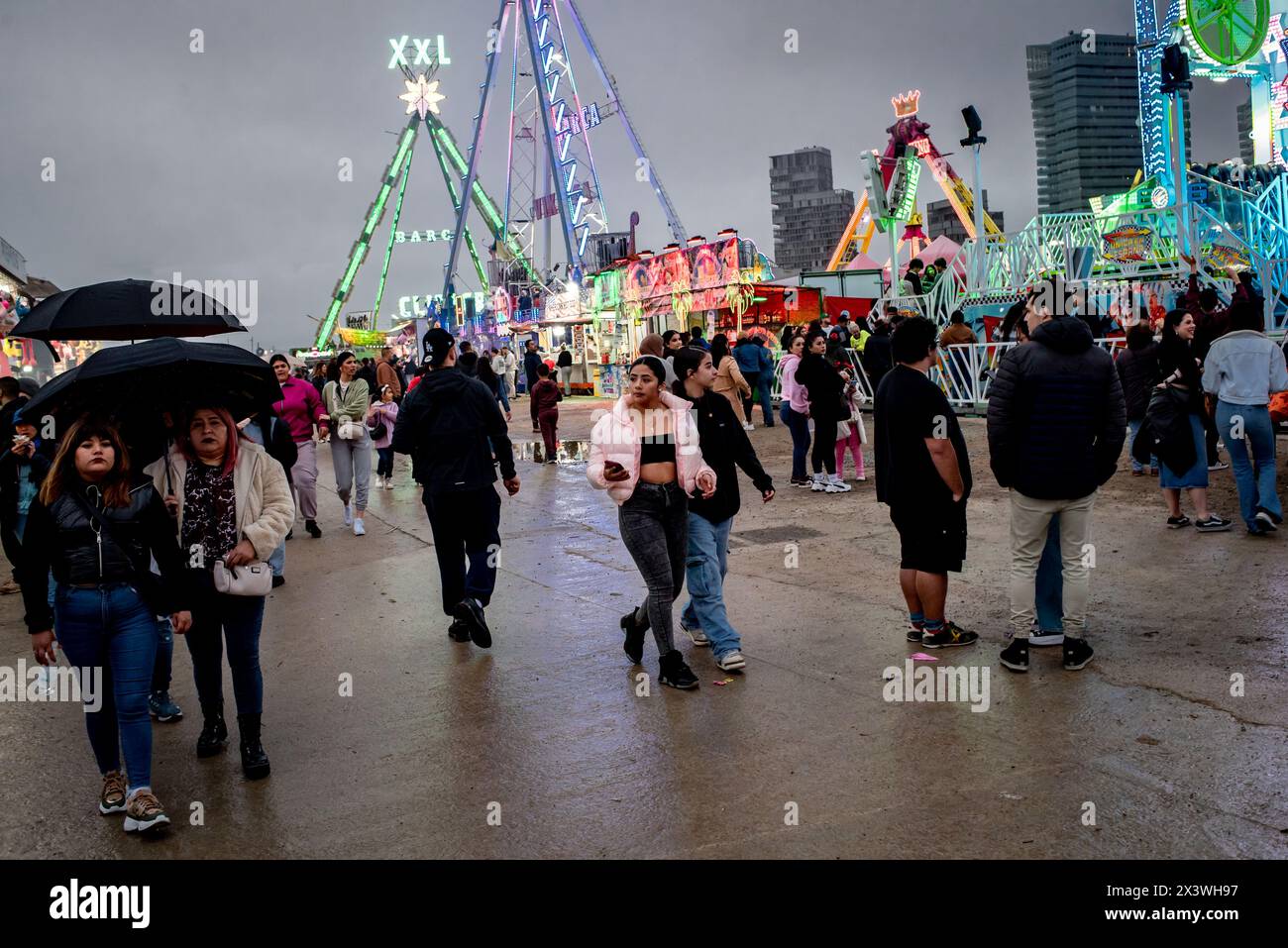 People visit an amusement park located in the Parc del Forum of ...