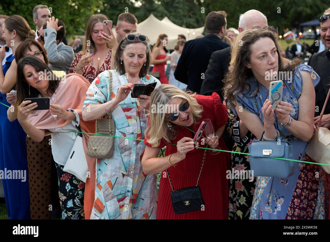 Wealthy rich women using smartphones UK 2020s. Hurlingham Club is an ...
