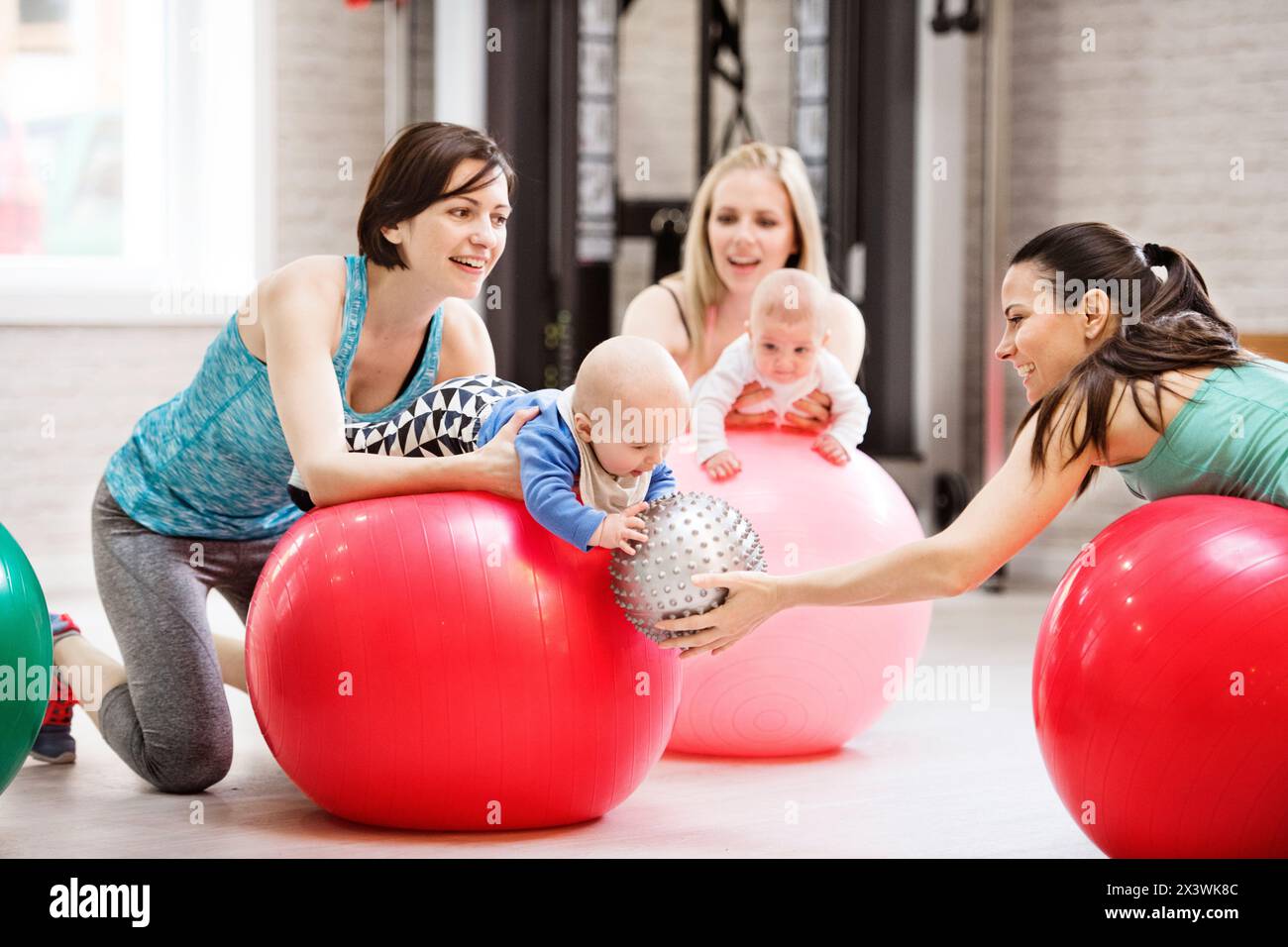 Baby movement class. Parents helping babies to improve motor skills ...