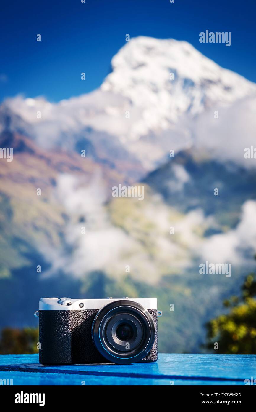 Compact digital camera placed on a map in front of beautifaul snow ...
