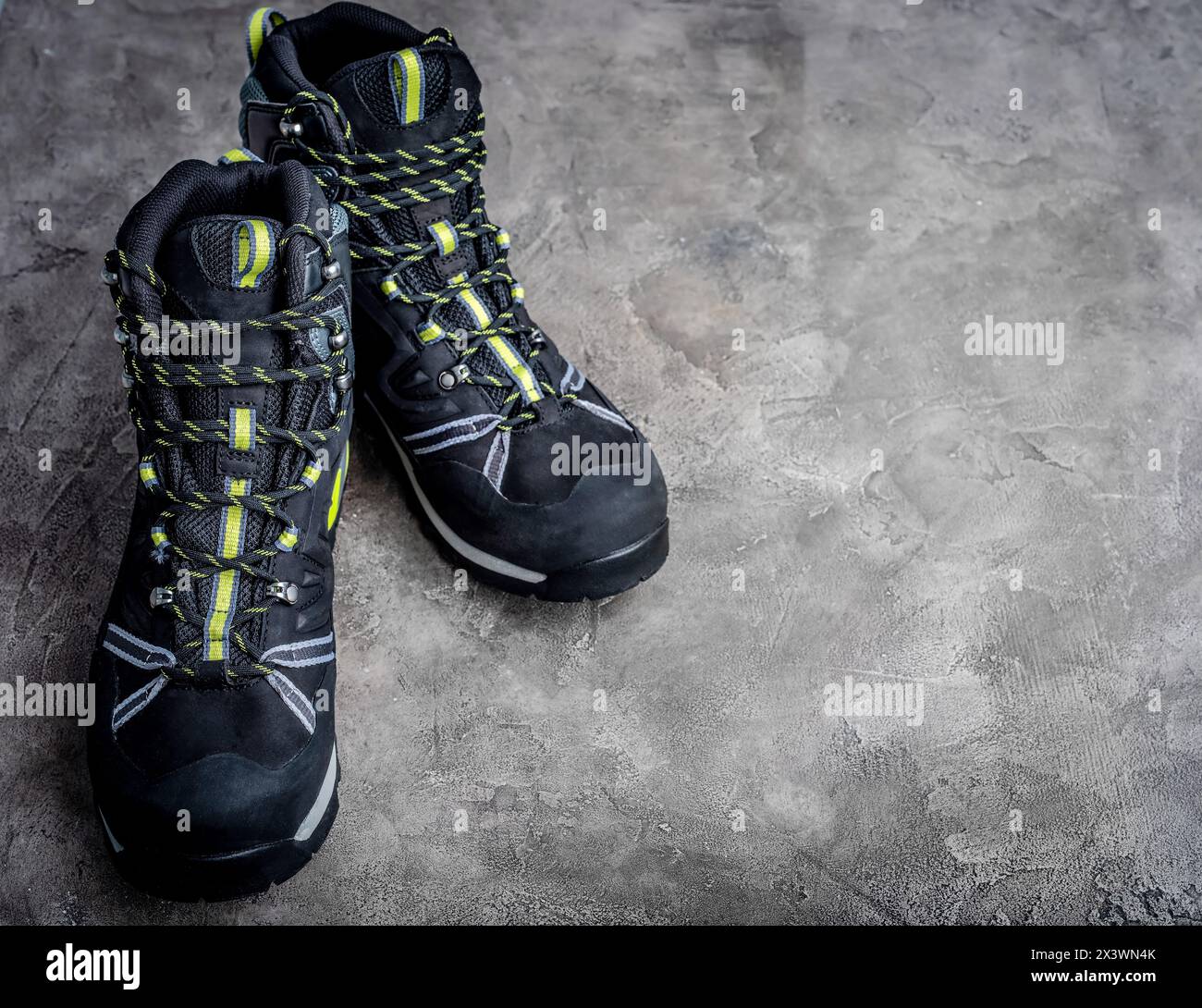 Black hiking boots on the dark table Stock Photo - Alamy