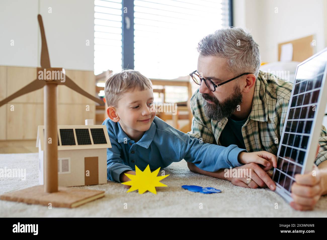 Father explaining renewable energy, teaching about sustainable ...