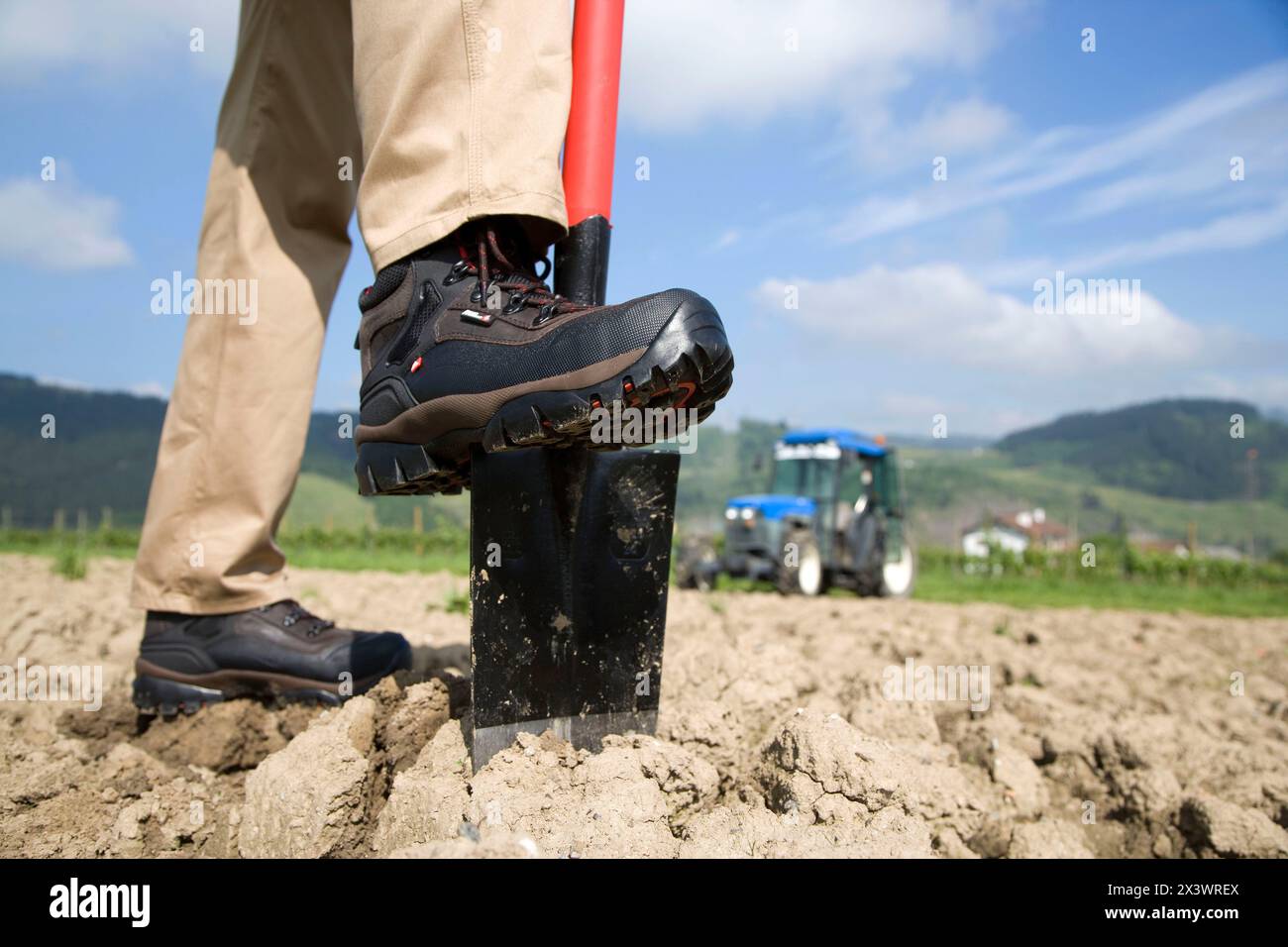 Protective boots, spade, farm tool, field Stock Photo - Alamy