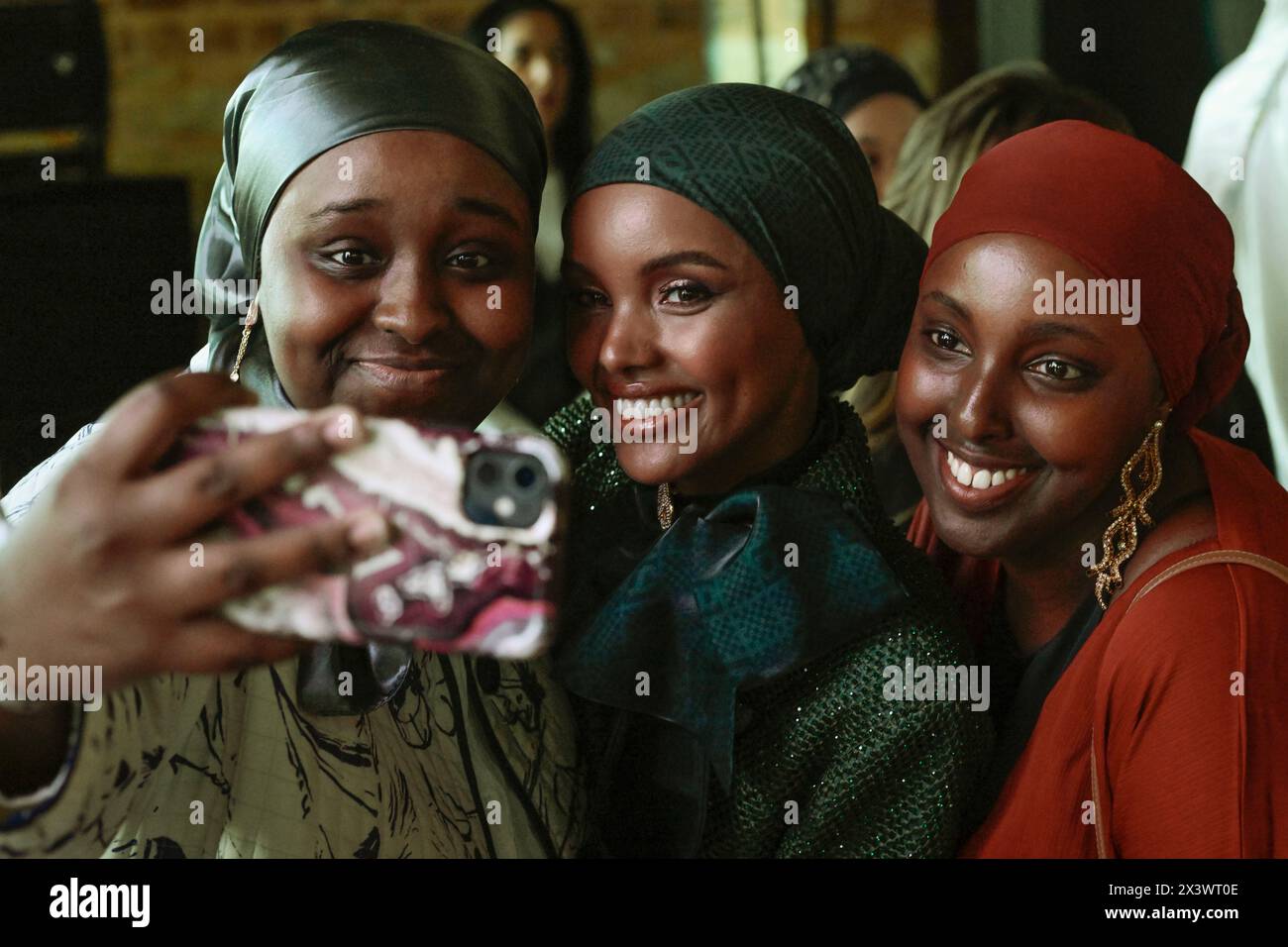 Two girls of African origin seen taking selfie with Halima Aden (C ...