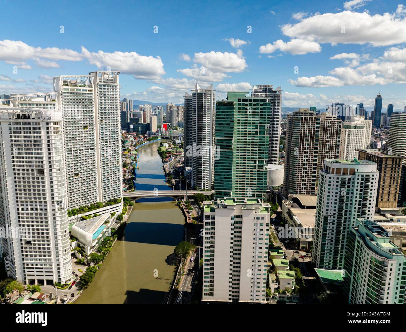 Residential modern buildings with river. Metro Manila. High rise towers ...