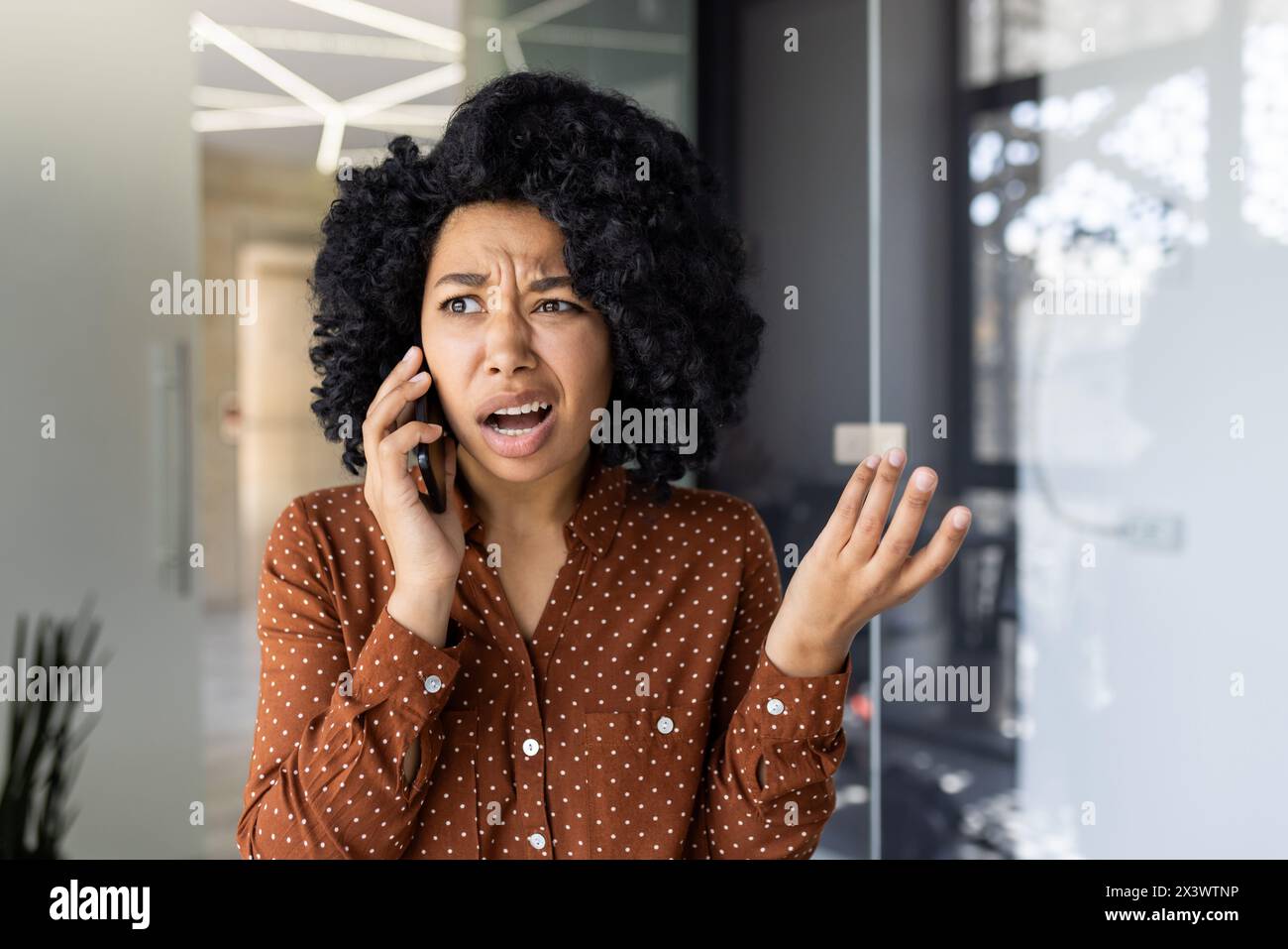 A young Black woman expresses frustration and confusion while talking ...