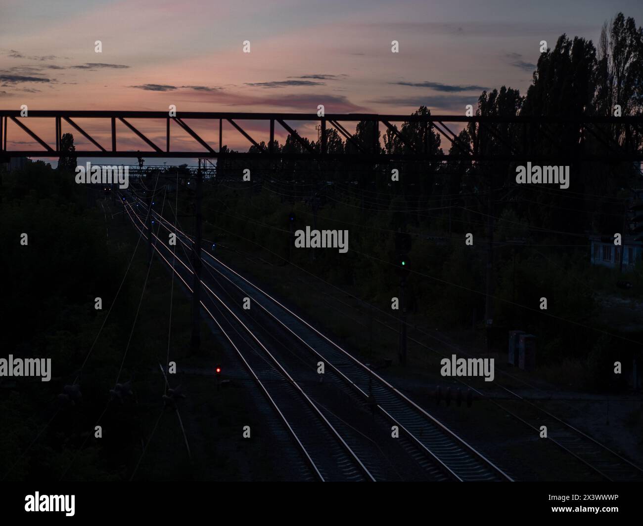 Top view over a shiny railroad with traffic lights and a train with ...