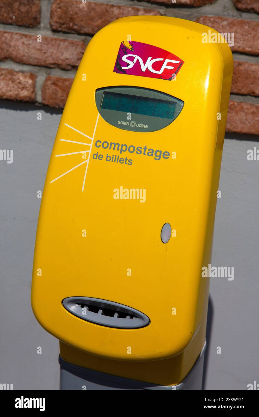Yellow terminal for composting SNCF train tickets Stock Photo - Alamy