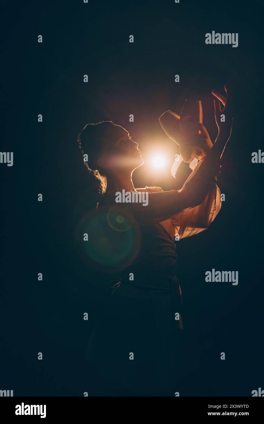 Closeup view to young ballerina holding pointe shoes in her hands on ...