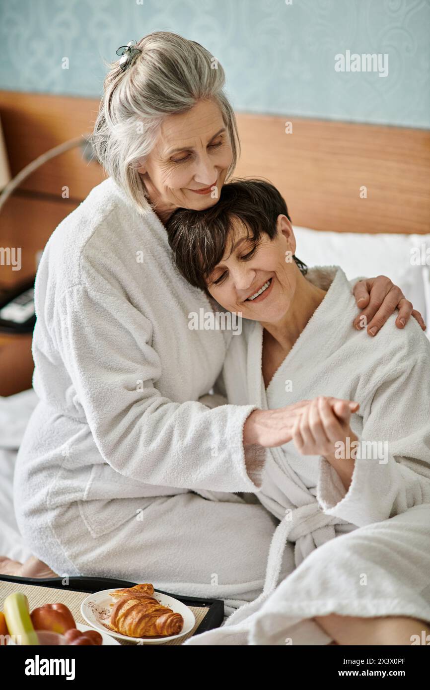 Tender Moment Between Loving Senior Lesbian Couple Hugging In Bed