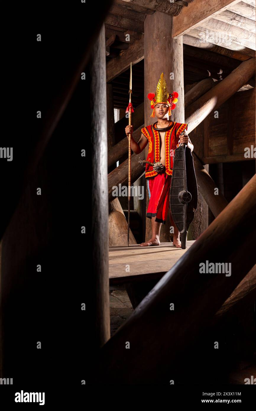 A traditional stone jumper, dressed in ceremonial attire, poses with a ...