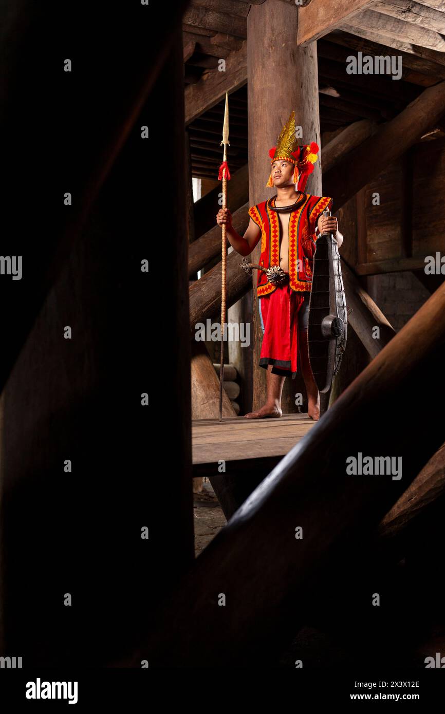 A traditional stone jumper, dressed in ceremonial attire, poses with a ...