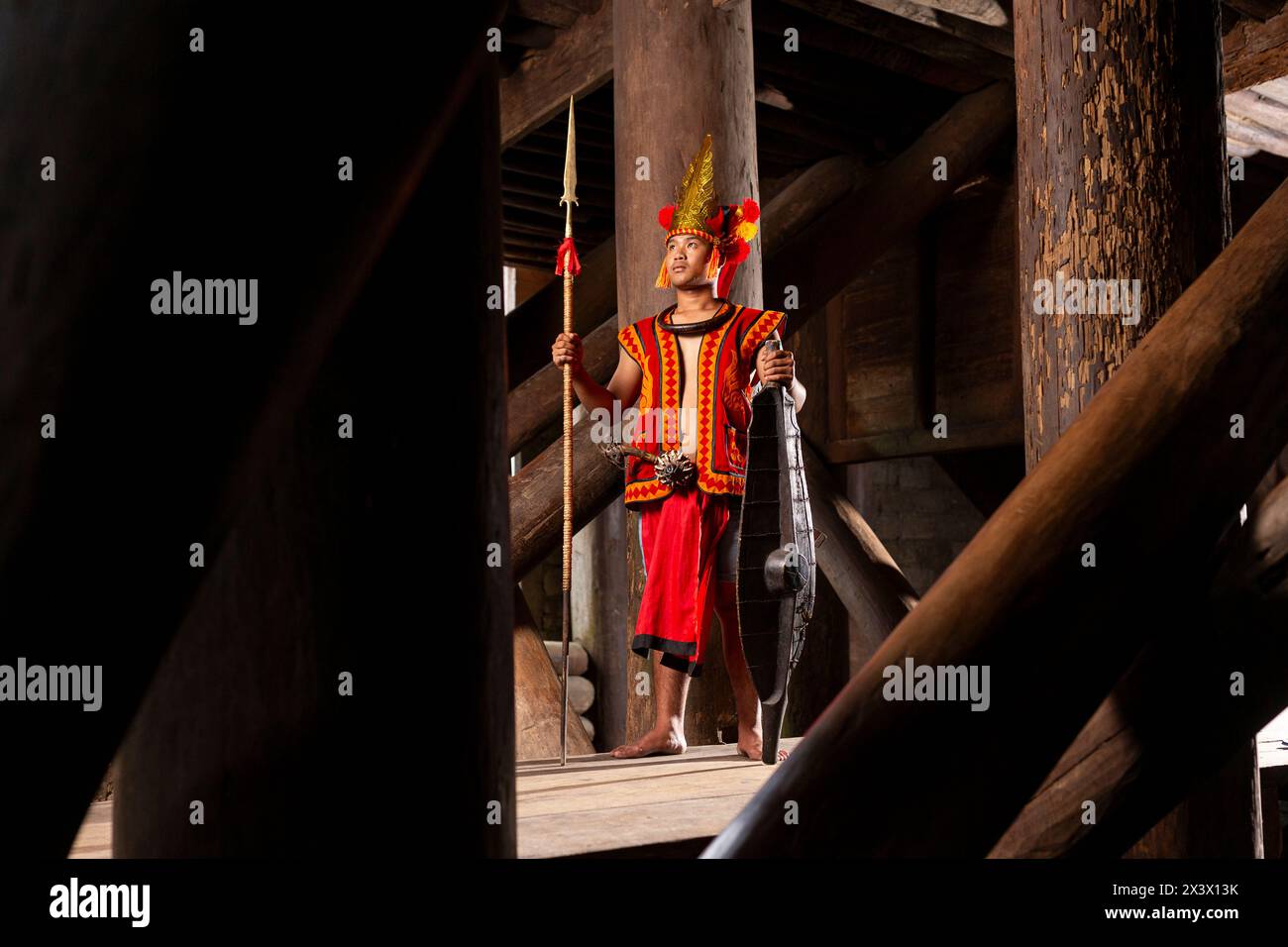 A traditional stone jumper, dressed in ceremonial attire, poses with a ...