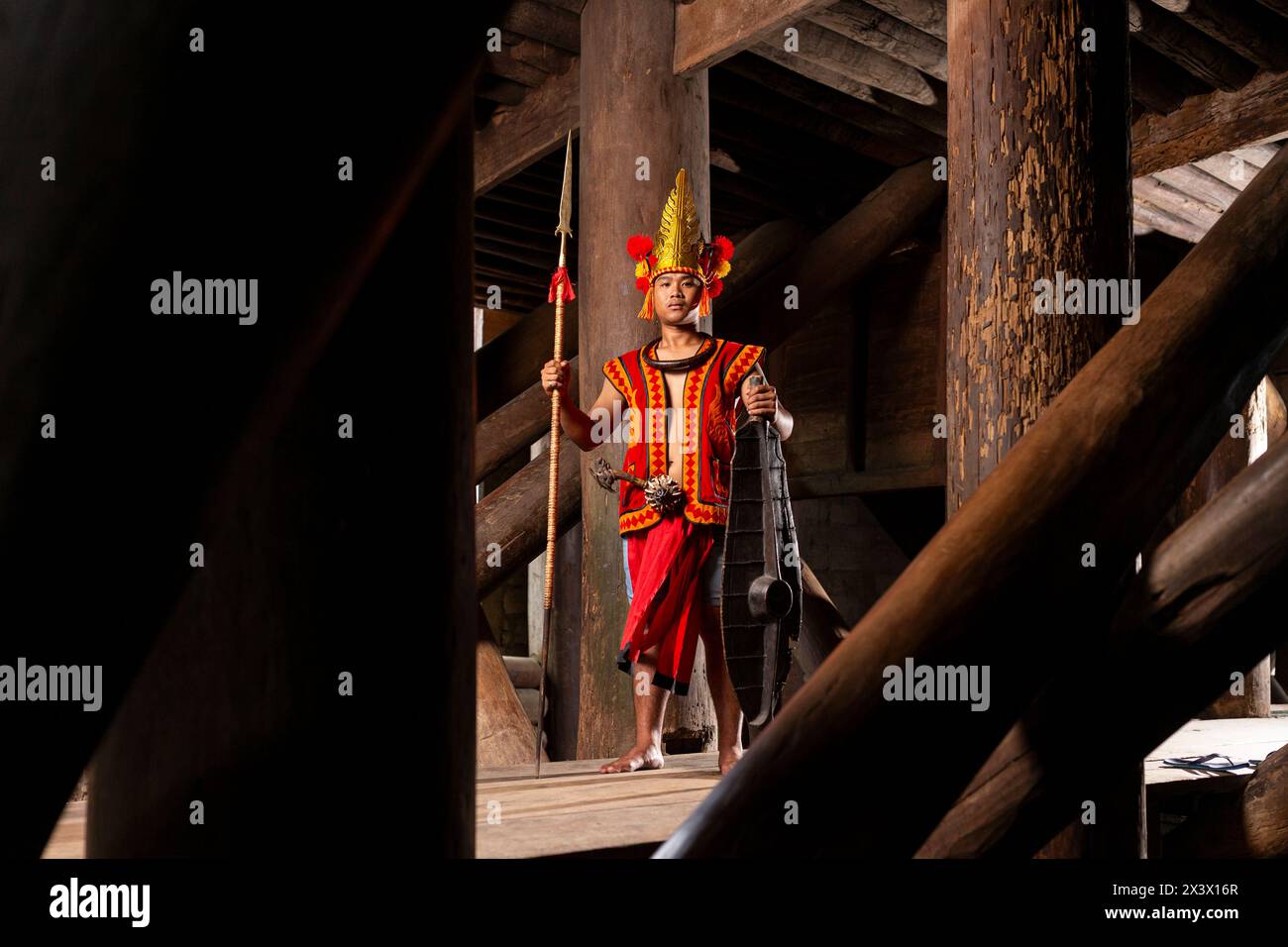 A traditional stone jumper, dressed in ceremonial attire, poses with a ...