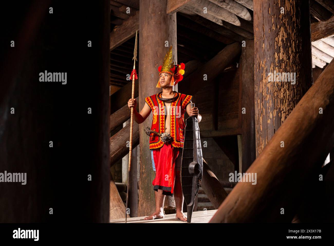 A traditional stone jumper, dressed in ceremonial attire, poses with a ...