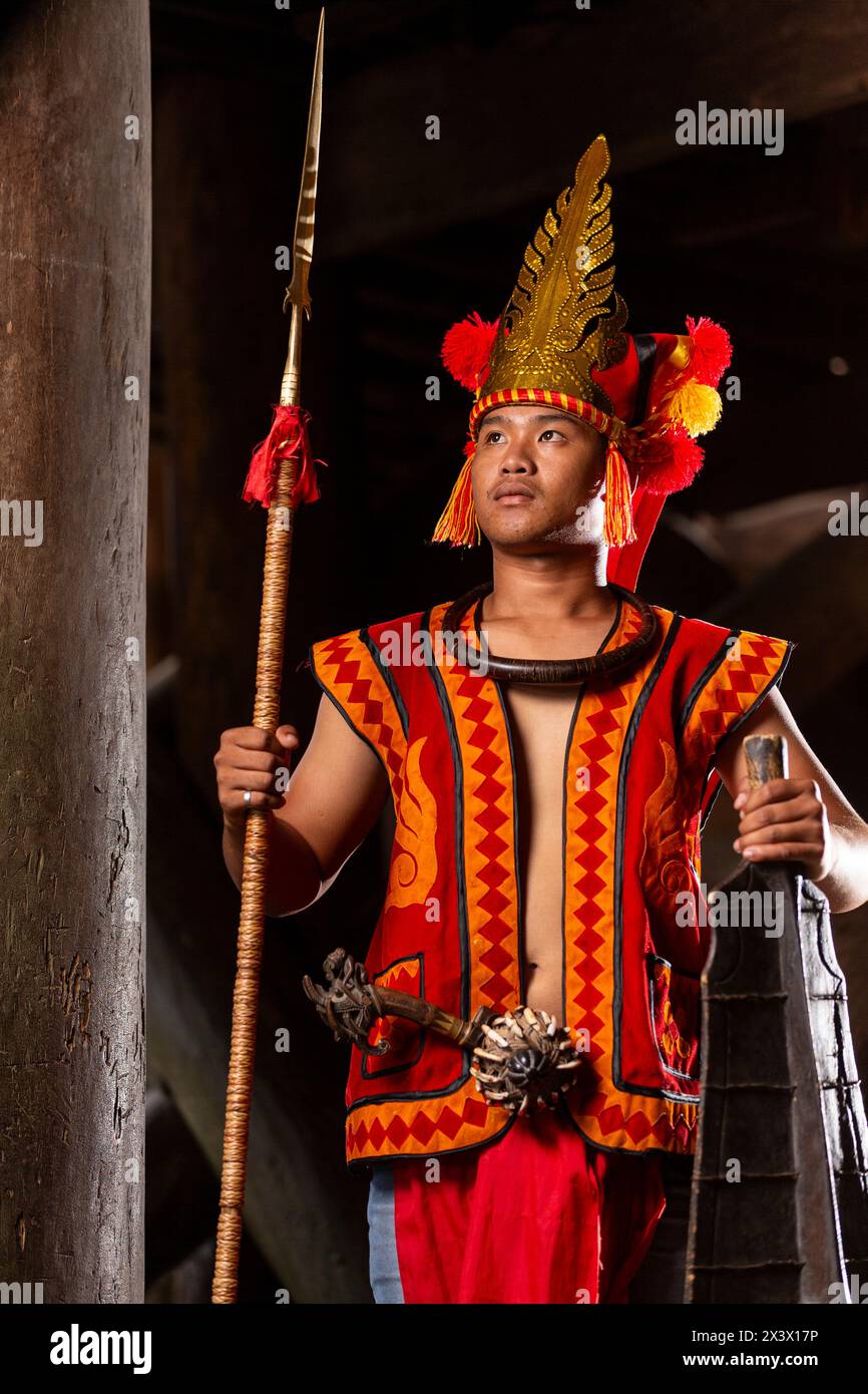 A traditional stone jumper, dressed in ceremonial attire, poses with a ...