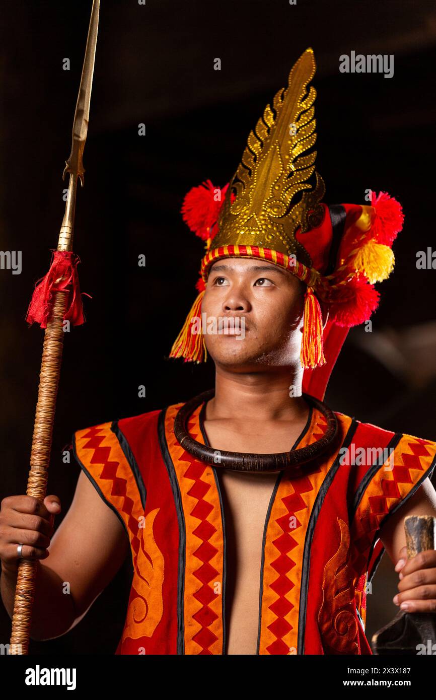 A traditional stone jumper, dressed in ceremonial attire, poses with a ...