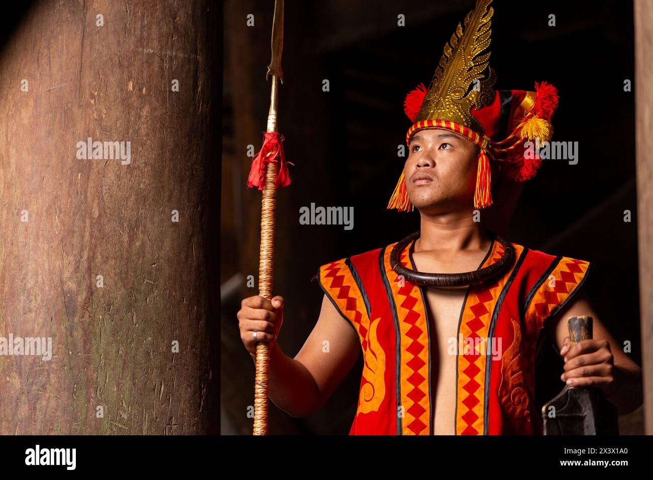 A traditional stone jumper, dressed in ceremonial attire, poses with a ...