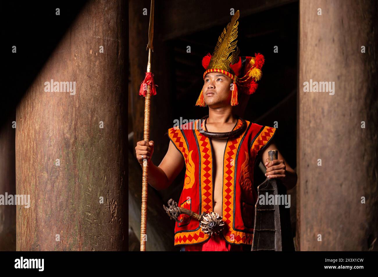 A traditional stone jumper, dressed in ceremonial attire, poses with a ...
