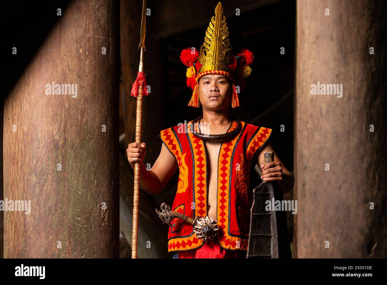 A traditional stone jumper, dressed in ceremonial attire, poses with a ...