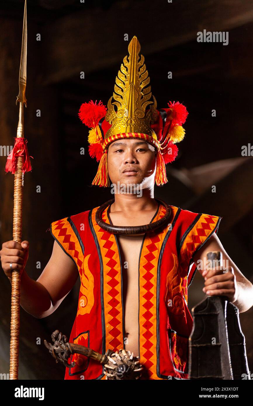 A traditional stone jumper, dressed in ceremonial attire, poses with a ...