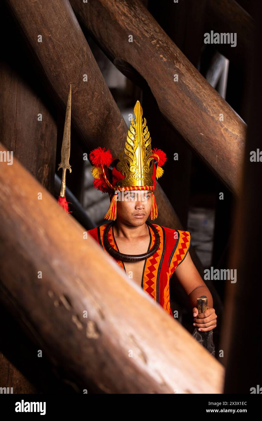 A traditional stone jumper, dressed in ceremonial attire, poses with a ...
