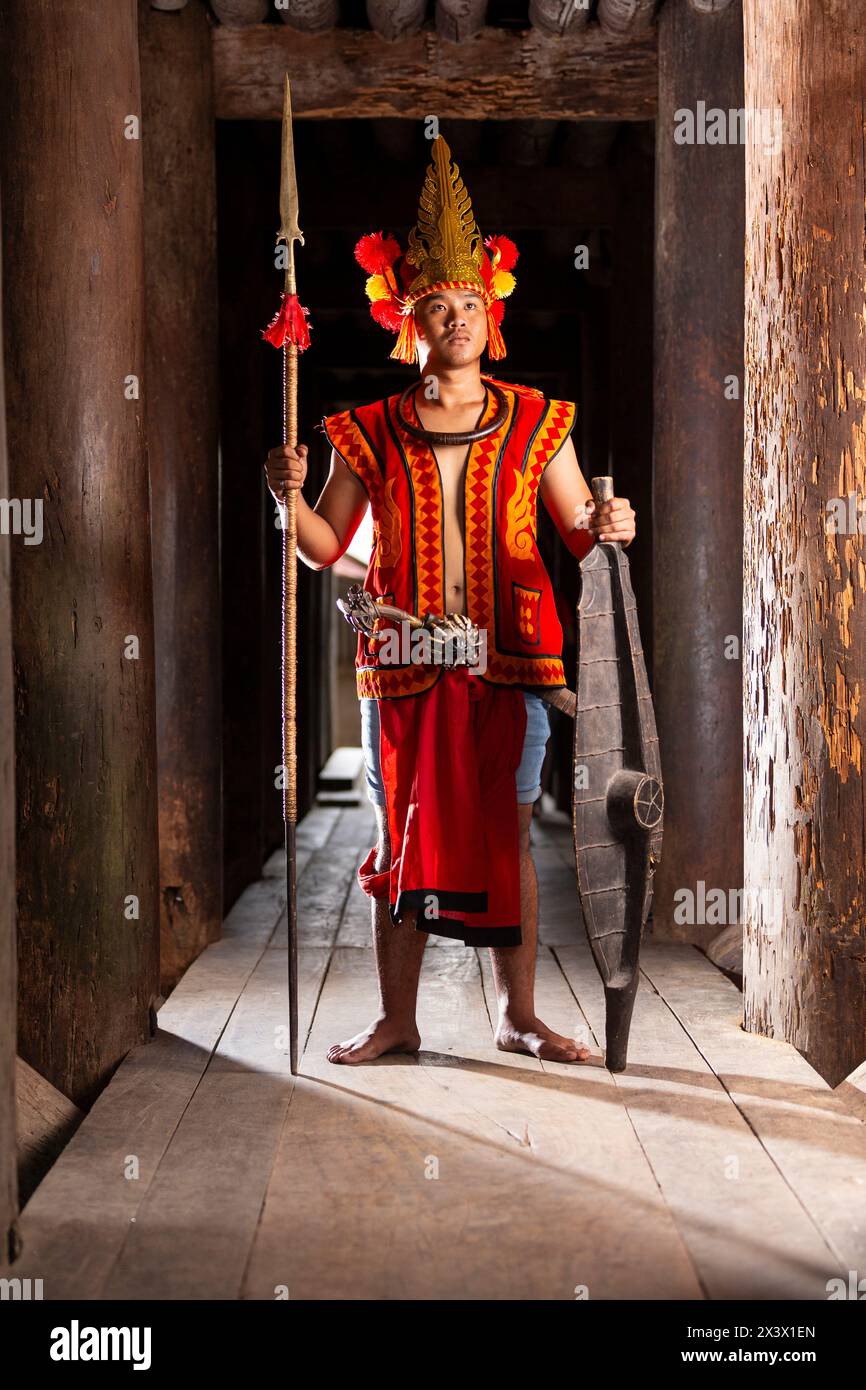 A traditional stone jumper, dressed in ceremonial attire, poses with a ...