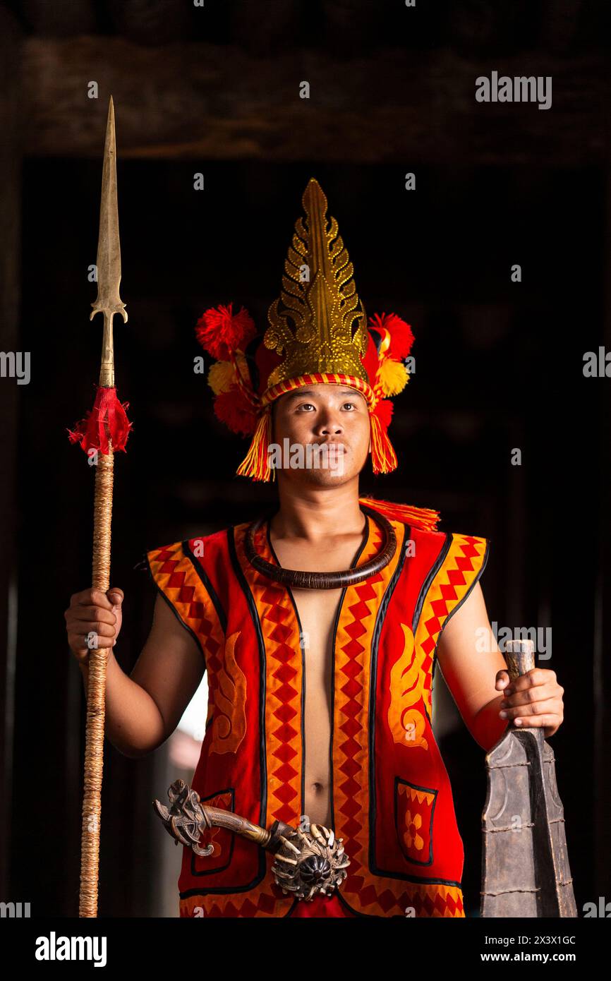 A traditional stone jumper, dressed in ceremonial attire, poses with a ...