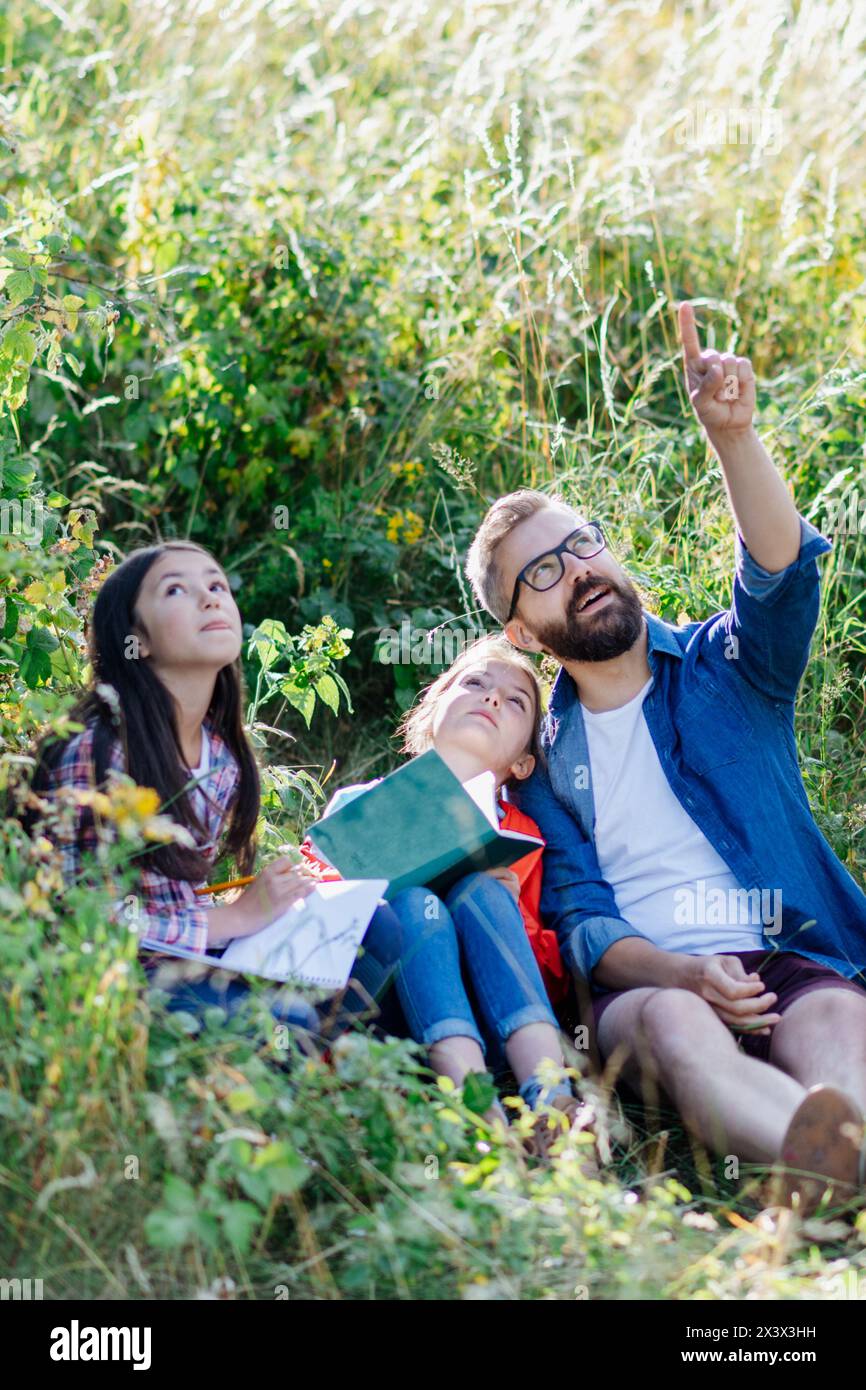 Young students learning about nature, forest ecosystem during biology ...
