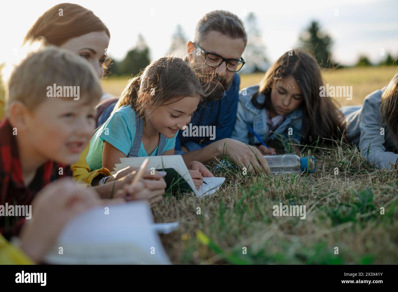 Young students learning about nature, forest ecosystem during biology ...