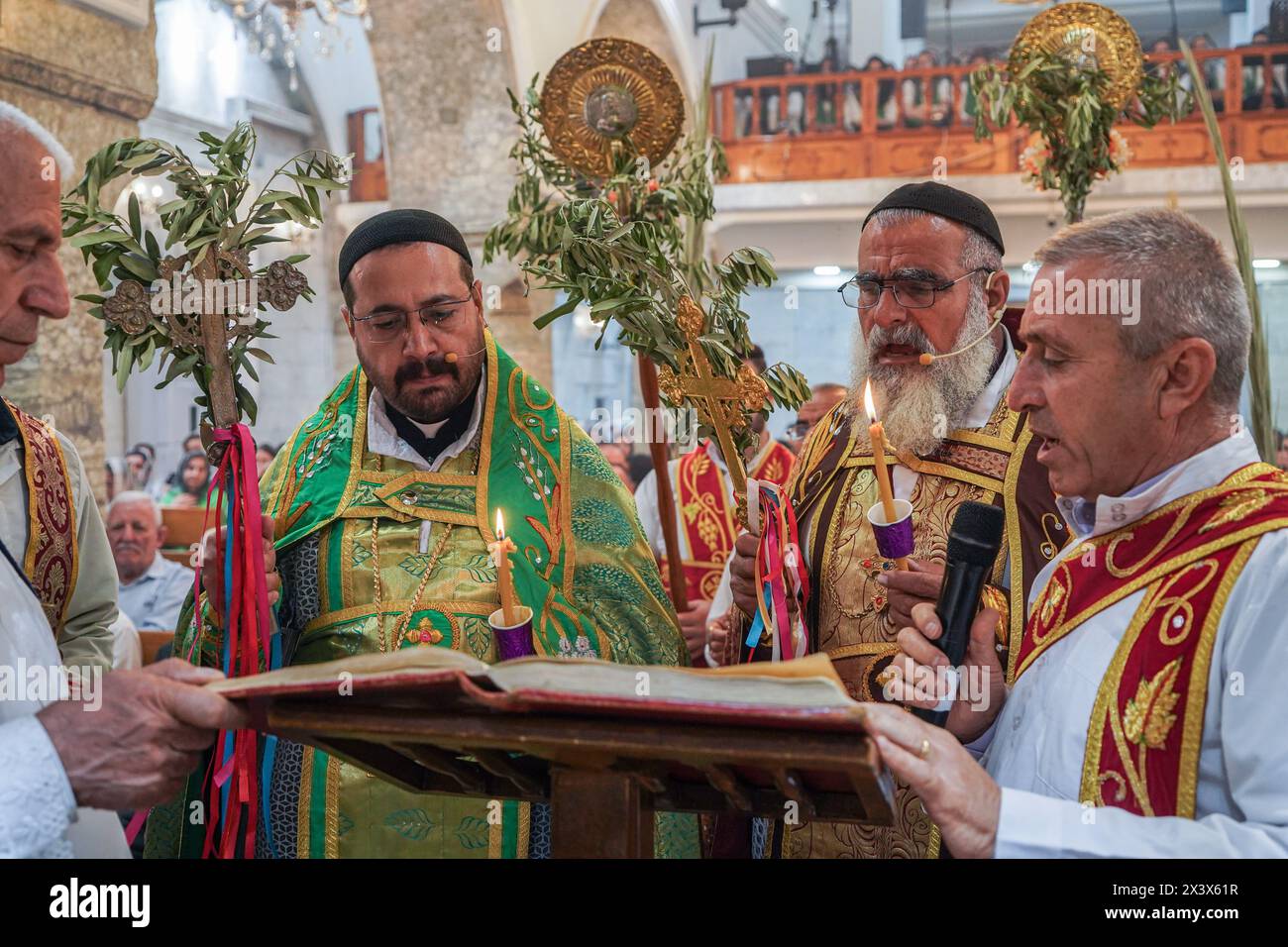 Bartella, Iraq. 28th Apr, 2024. Priests lead the Palm Sunday service ...
