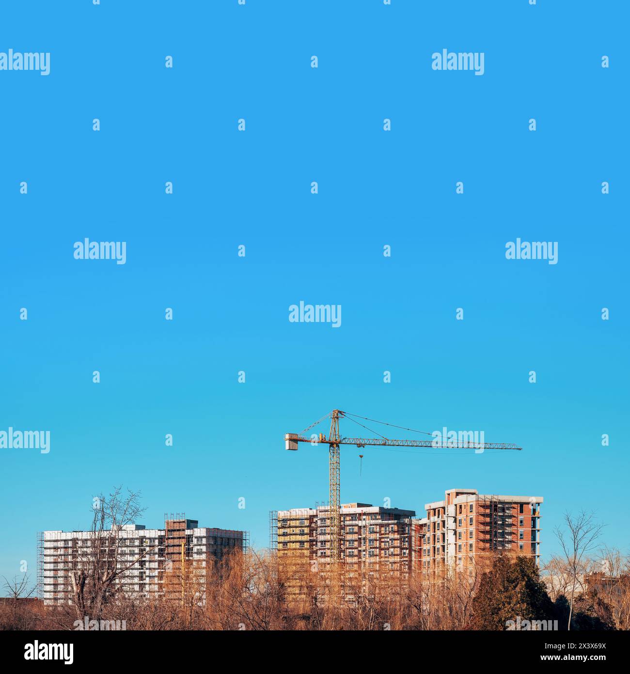 Residential building skyscrapers construction site with tall cranes and ...