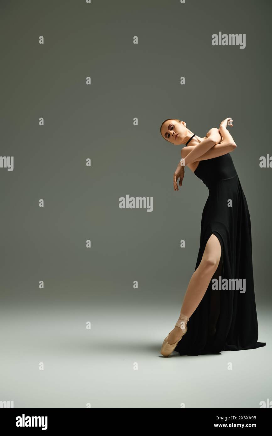 A young, talented ballerina gracefully dances in a stunning black dress ...