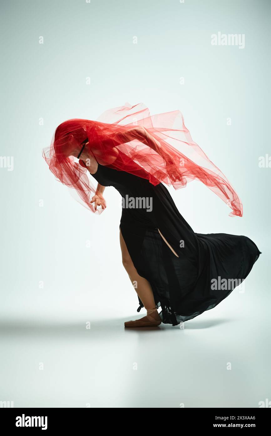A young beautiful ballerina in a black dress dancing gracefully Stock ...