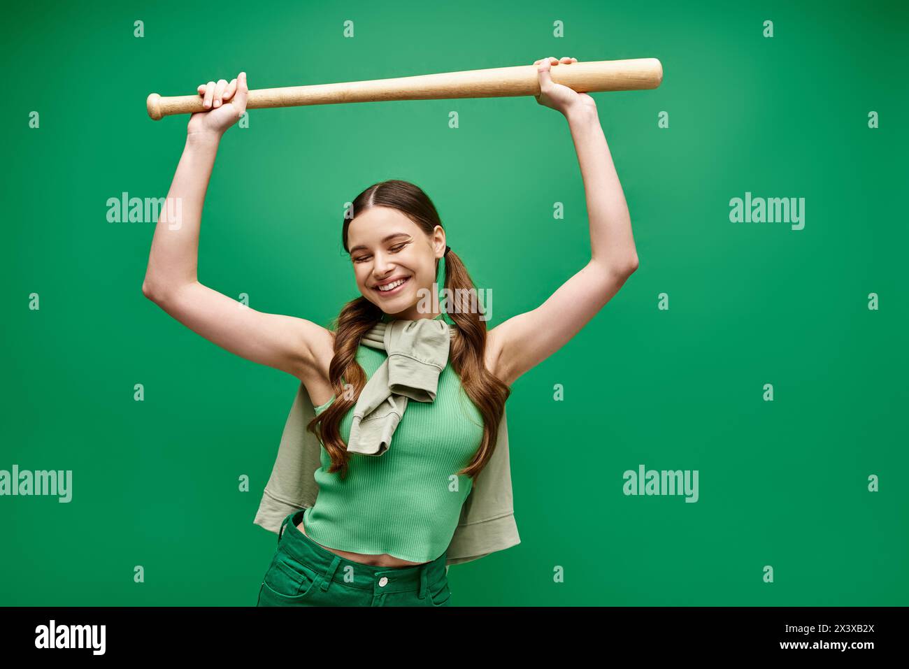 A young, beautiful woman in her 20s poses in a studio setting ...