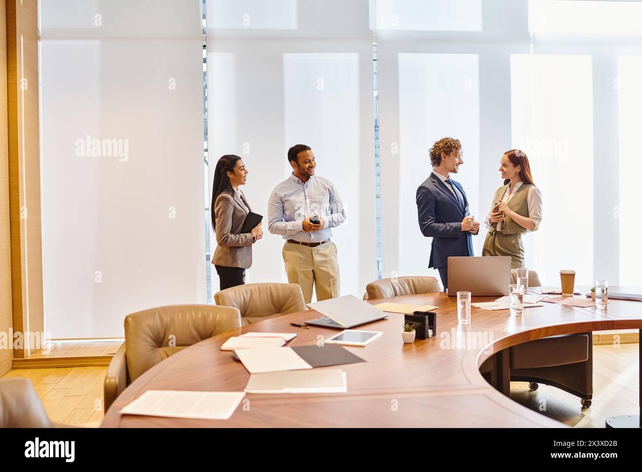 Multicultural professionals collaborating around a conference table ...