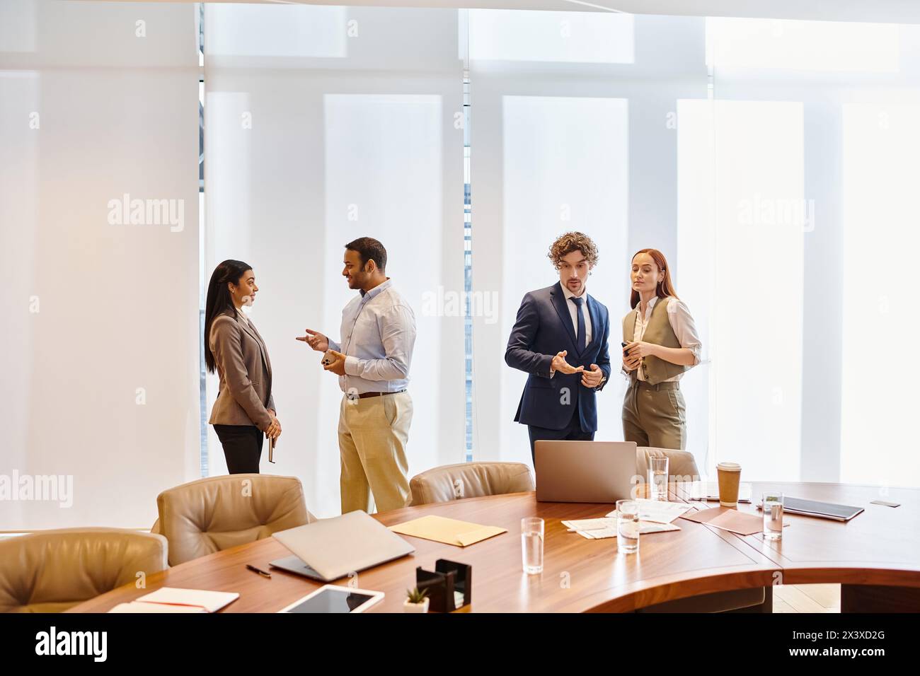 A diverse group of business professionals collaborating around a ...