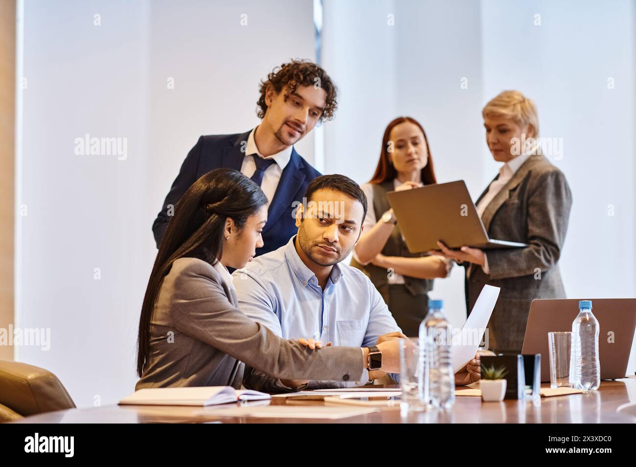 Multicultural business team collaborating around conference table Stock ...