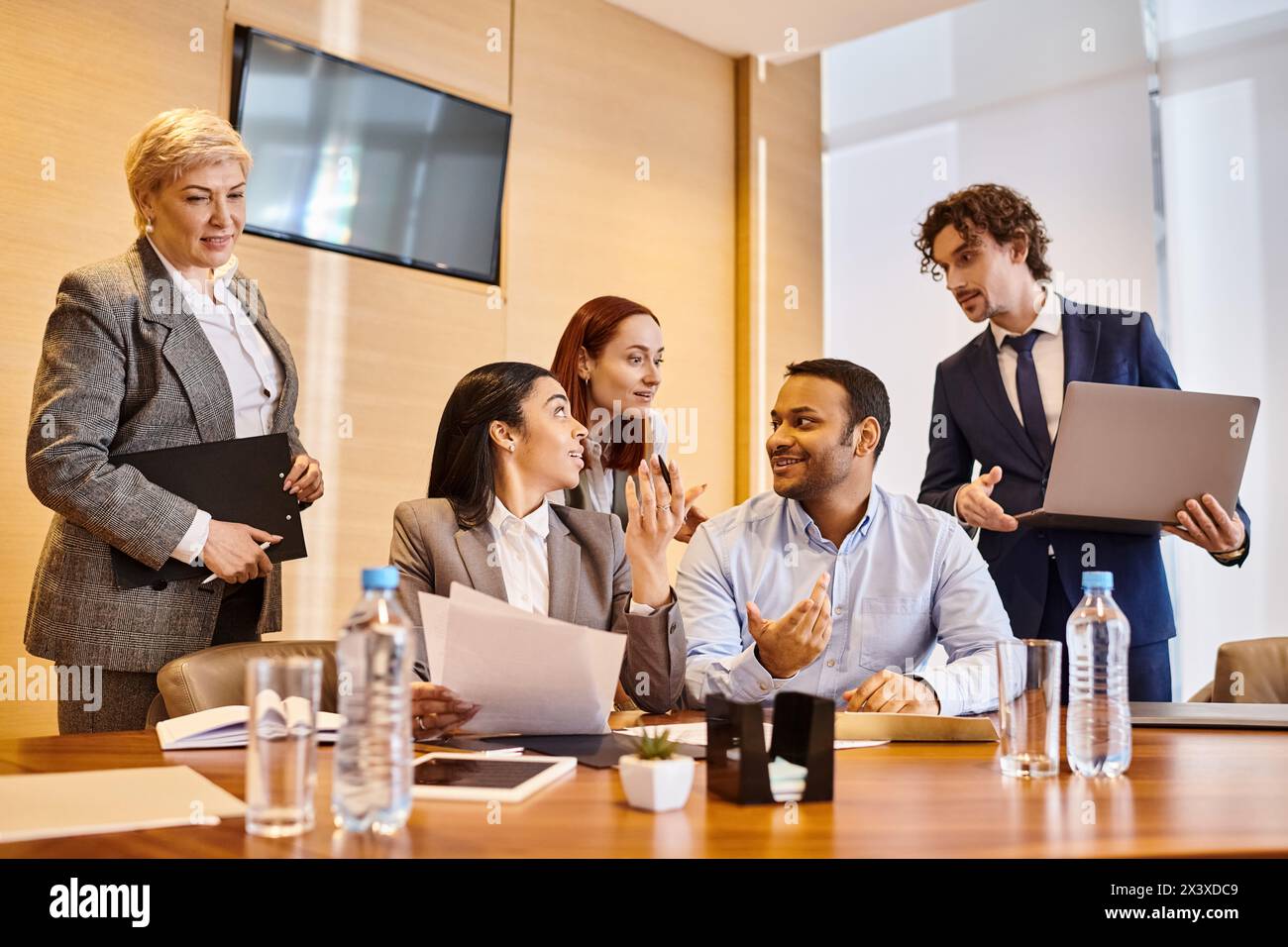 Multicultural professionals collaborating around a conference table ...