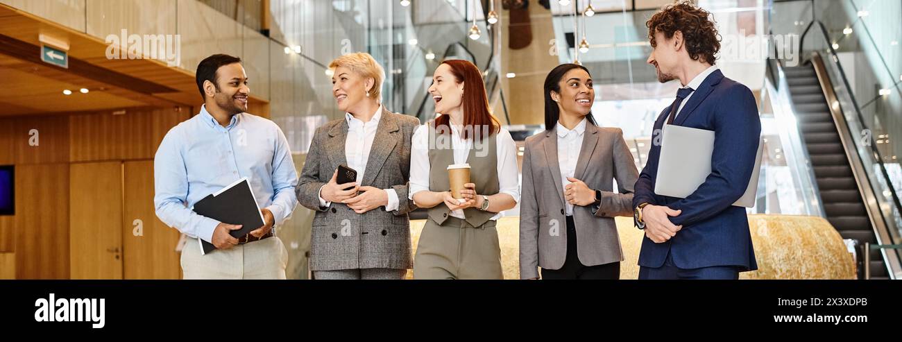 A diverse group of business professionals stand in a circle, discussing ...
