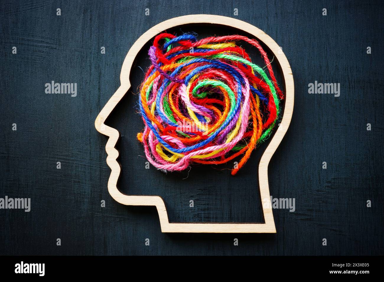 The outline of the head and a ball of colored threads as a symbol of ...