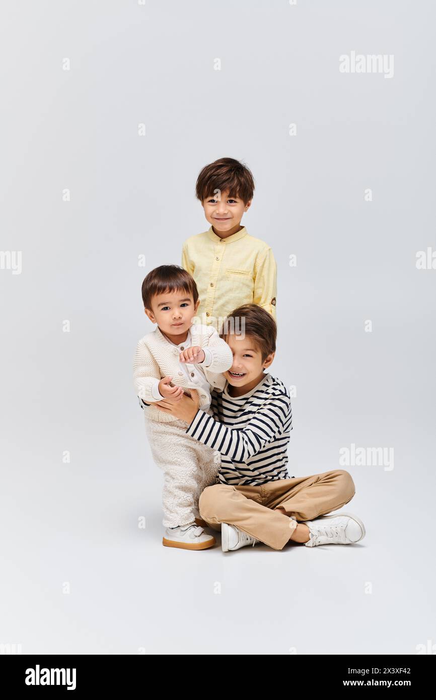 A diverse group of asian children posing together in a studio setting ...