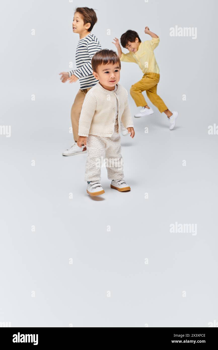 Group of young children, standing closely together in a studio against ...
