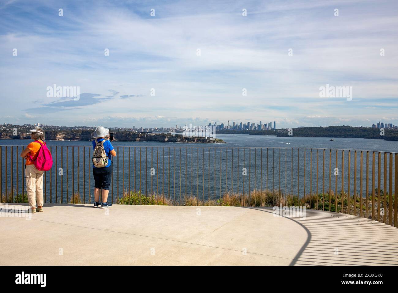 North Head Manly, two women friends stand at Burragula lookout view ...