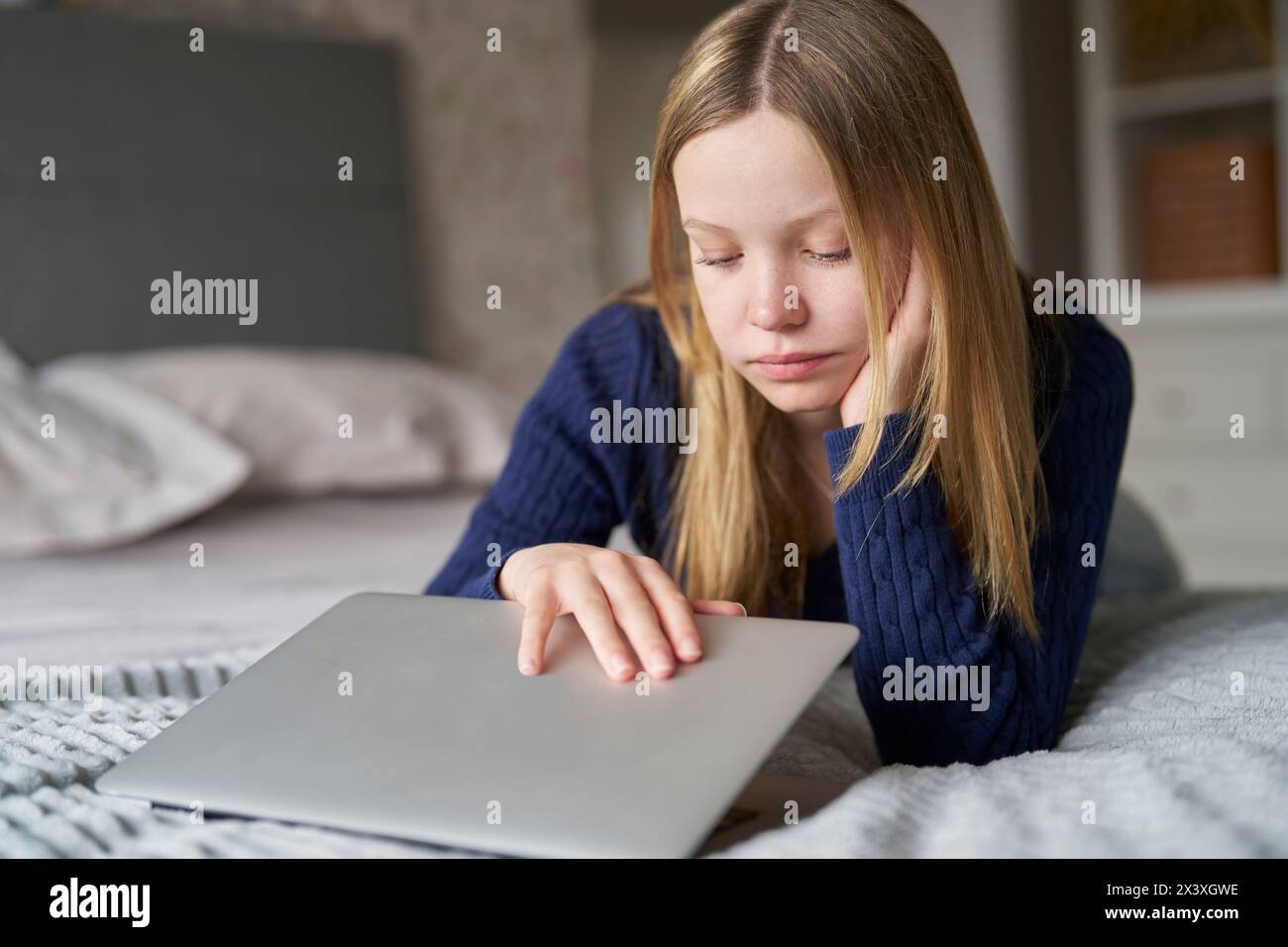 Unhappy Teenage Girl Closing Laptop Lying On Bed At Home Anxious About ...