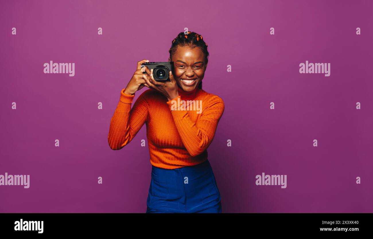 Young female photographer in casual clothing and vibrant two-tone ...